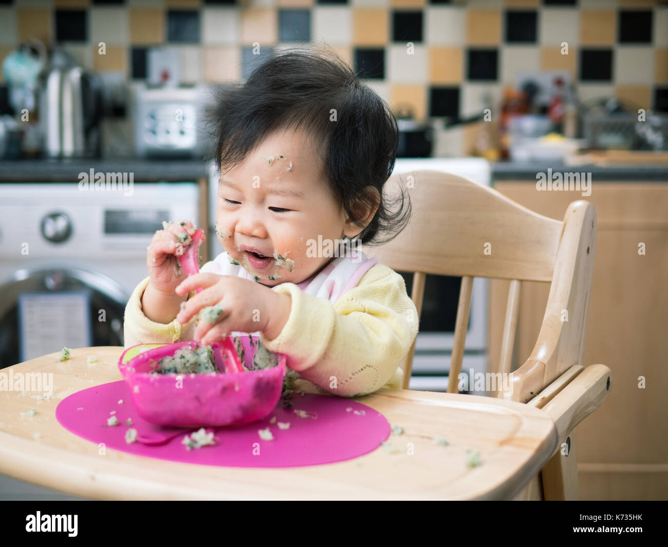 baby eating messy mashed potato Stock Photo - Alamy