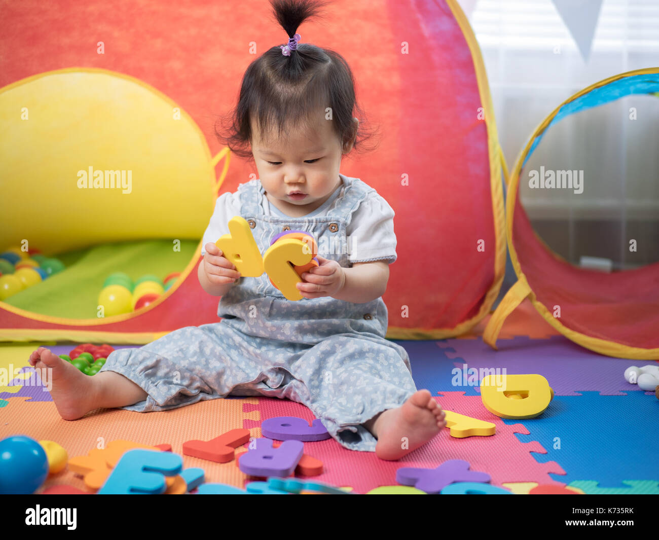 baby girl learning alphabet blocks Stock Photo - Alamy