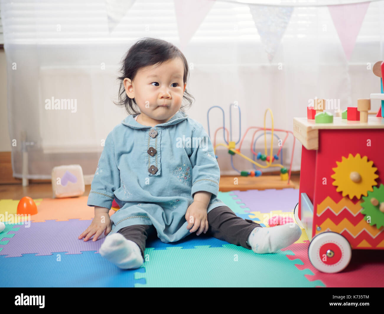 cute baby girl play toy at home Stock Photo - Alamy