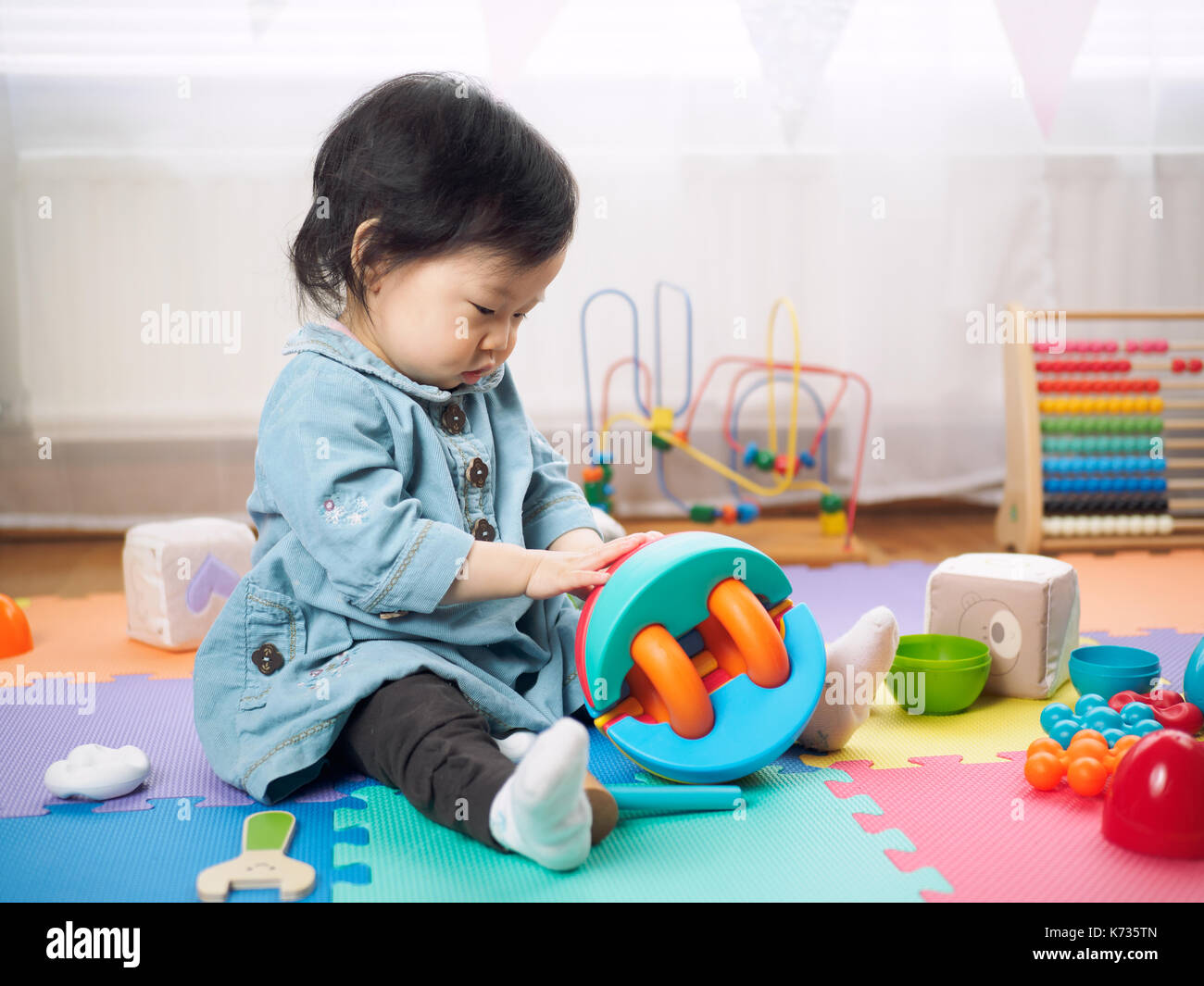 cute baby girl play toy at home Stock Photo - Alamy