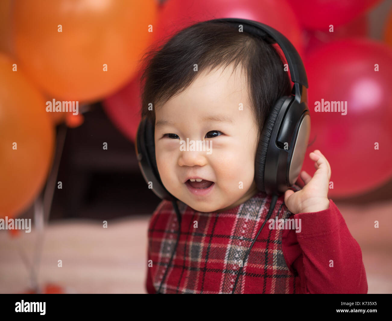happy baby girl listening music Stock Photo - Alamy