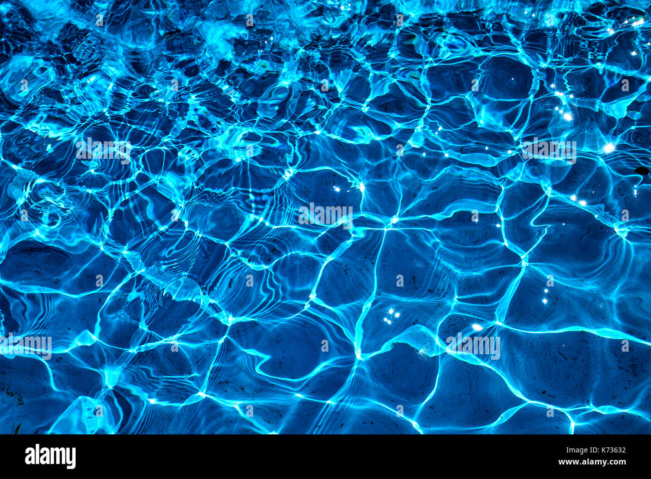 Water in swimming pool with sun reflection. Blue water. Water abstract ...