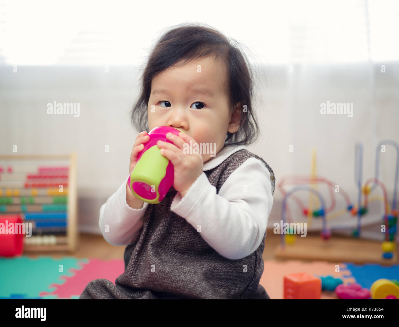 baby girl drinking water using a cup Stock Photo - Alamy