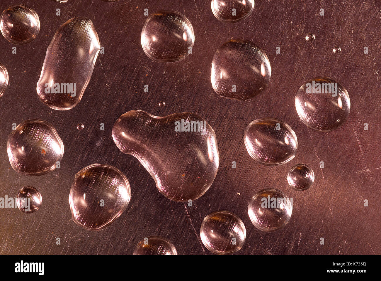 Abstract - water droplets against a coloured metal background Stock ...