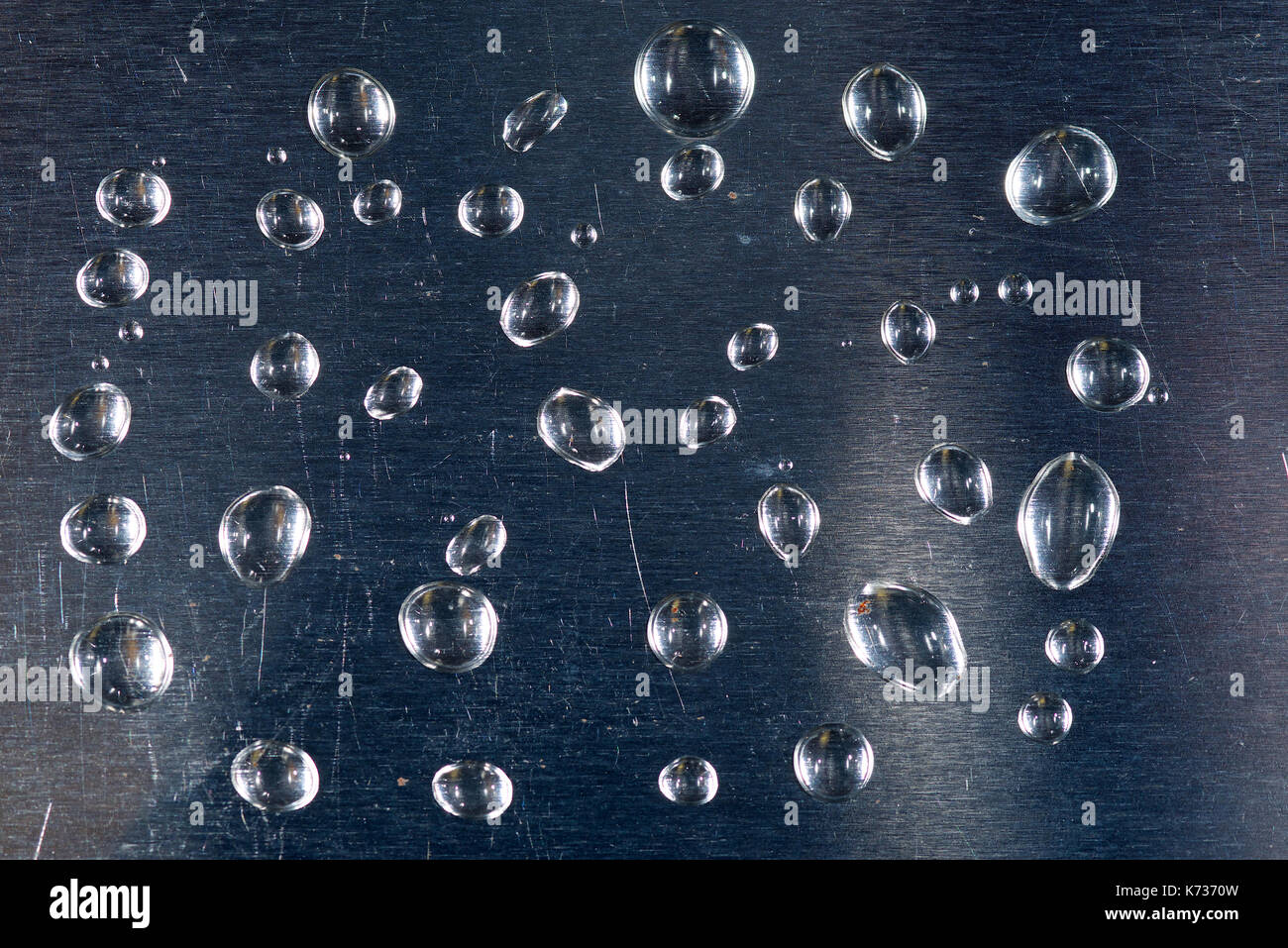 Abstract - water droplets against a coloured metal background Stock ...
