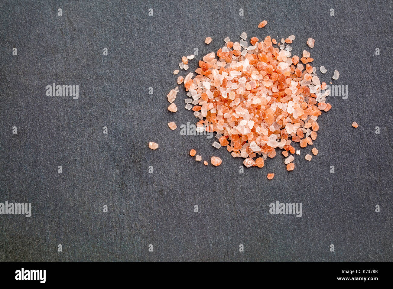 background of Himalayan salt - a heap of pink and orange coarse ...