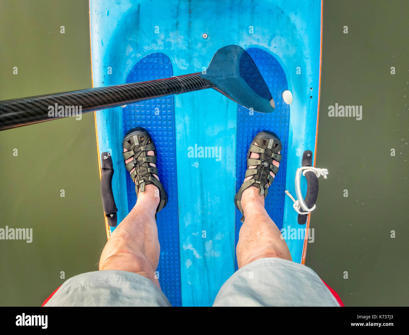 Narrow racing stand up paddleboard with a carbon fiber paddle and ...