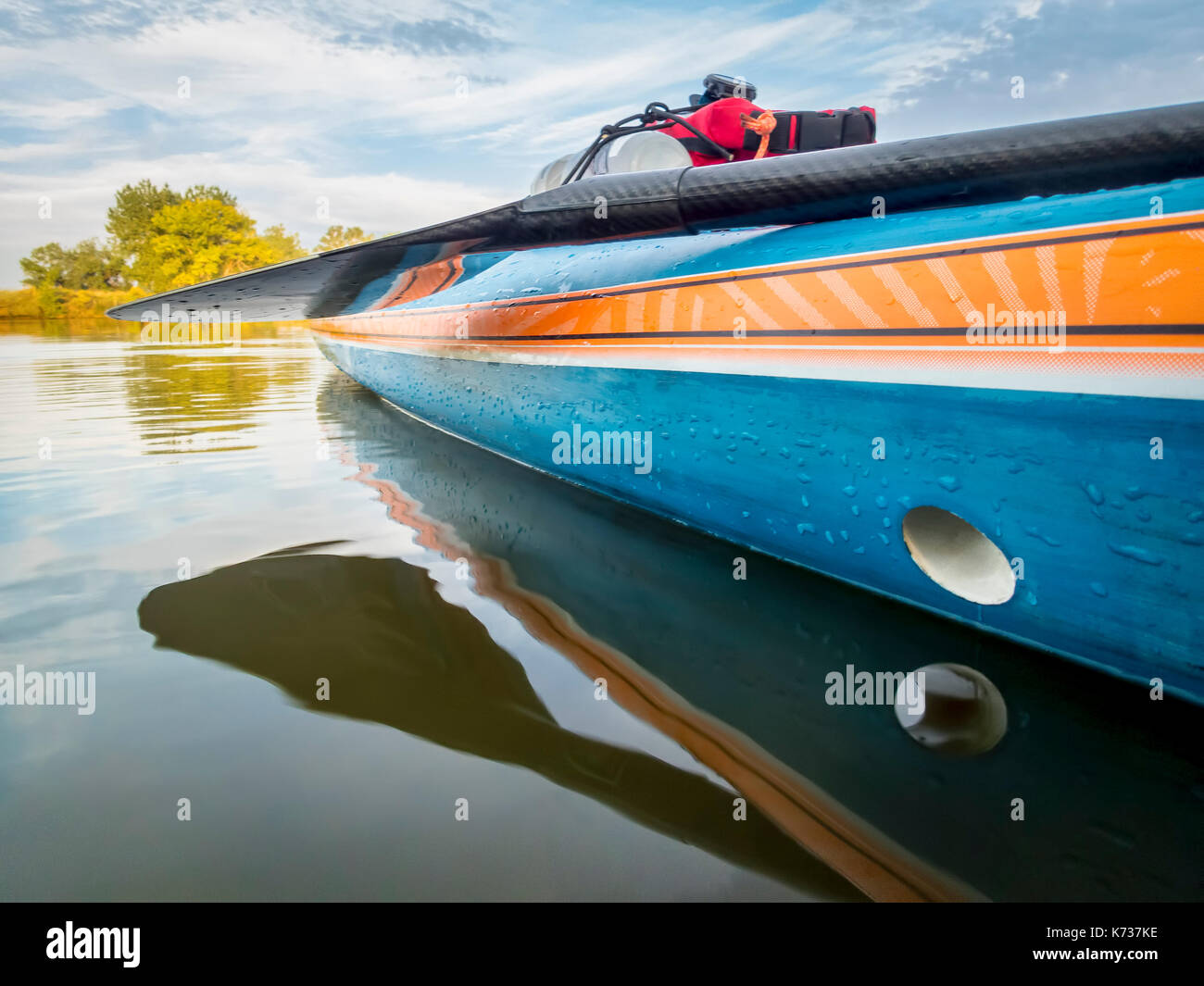 Stand up paddleboard with a paddle on a lake - low angle abstract shot ...