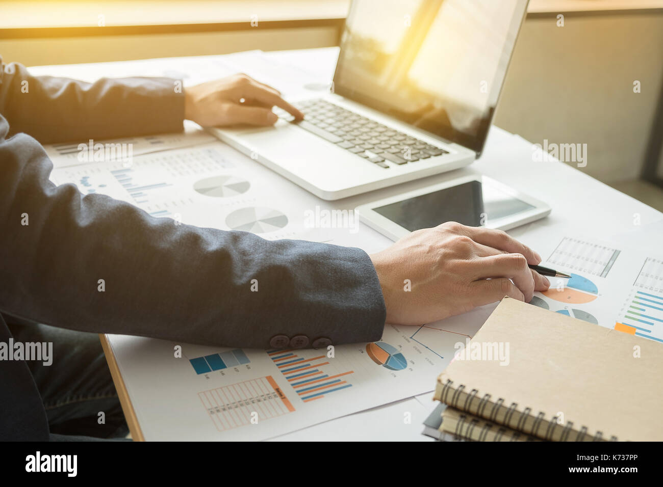 Close up of business man hand working on laptop computer with business ...