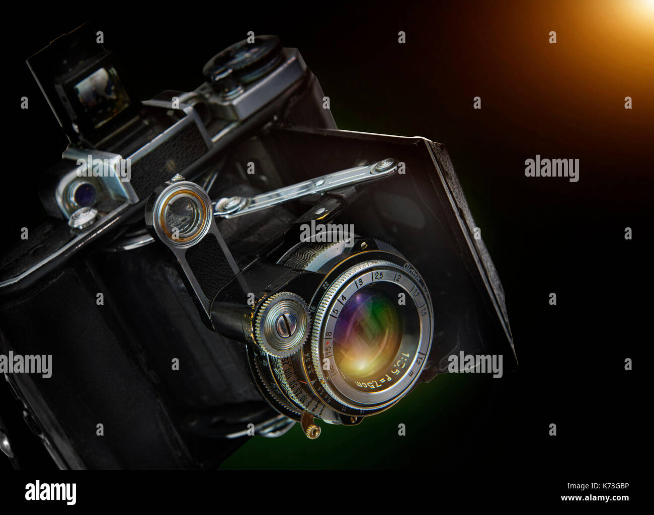 Old camera on a black background. Vintage Stock Photo - Alamy
