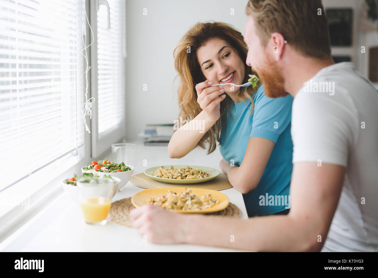 Couple having breakfast in the morning and smiling Stock Photo - Alamy