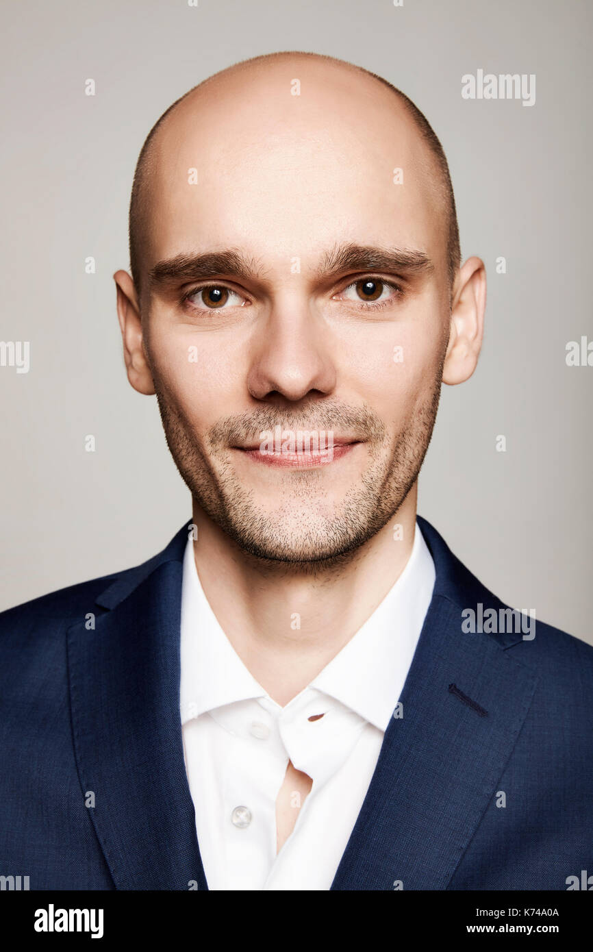 Close up of a young man in suit. Portrait on gray background Stock ...