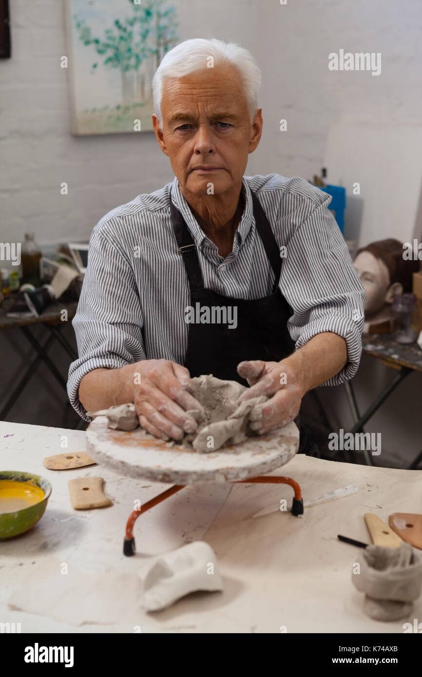 Portrait of senior man molding clay in drawing class Stock Photo - Alamy