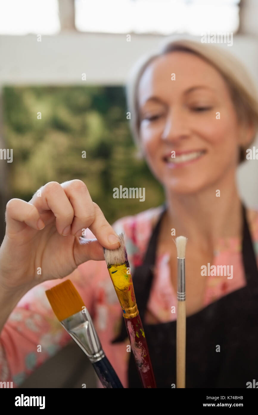 Woman painting in drawing book at drawing class Stock Photo - Alamy