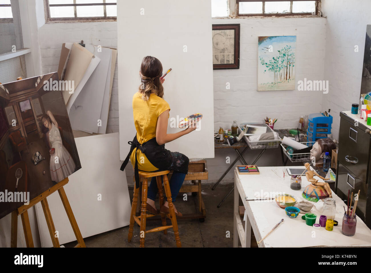 Woman painting on canvas in drawing class Stock Photo - Alamy