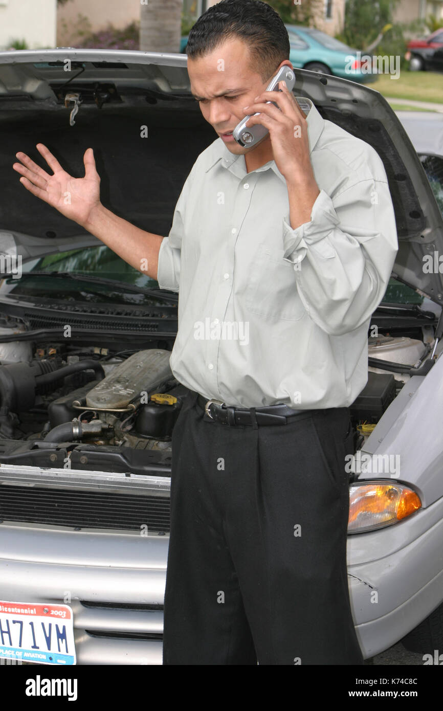 Man with disabled vehicle in need of repair Stock Photo - Alamy