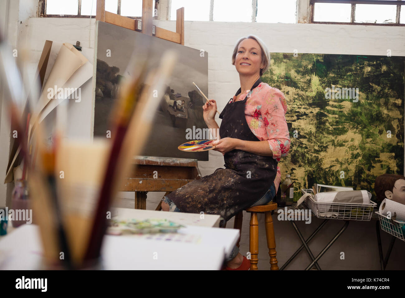 Woman painting on canvas in drawing class Stock Photo - Alamy