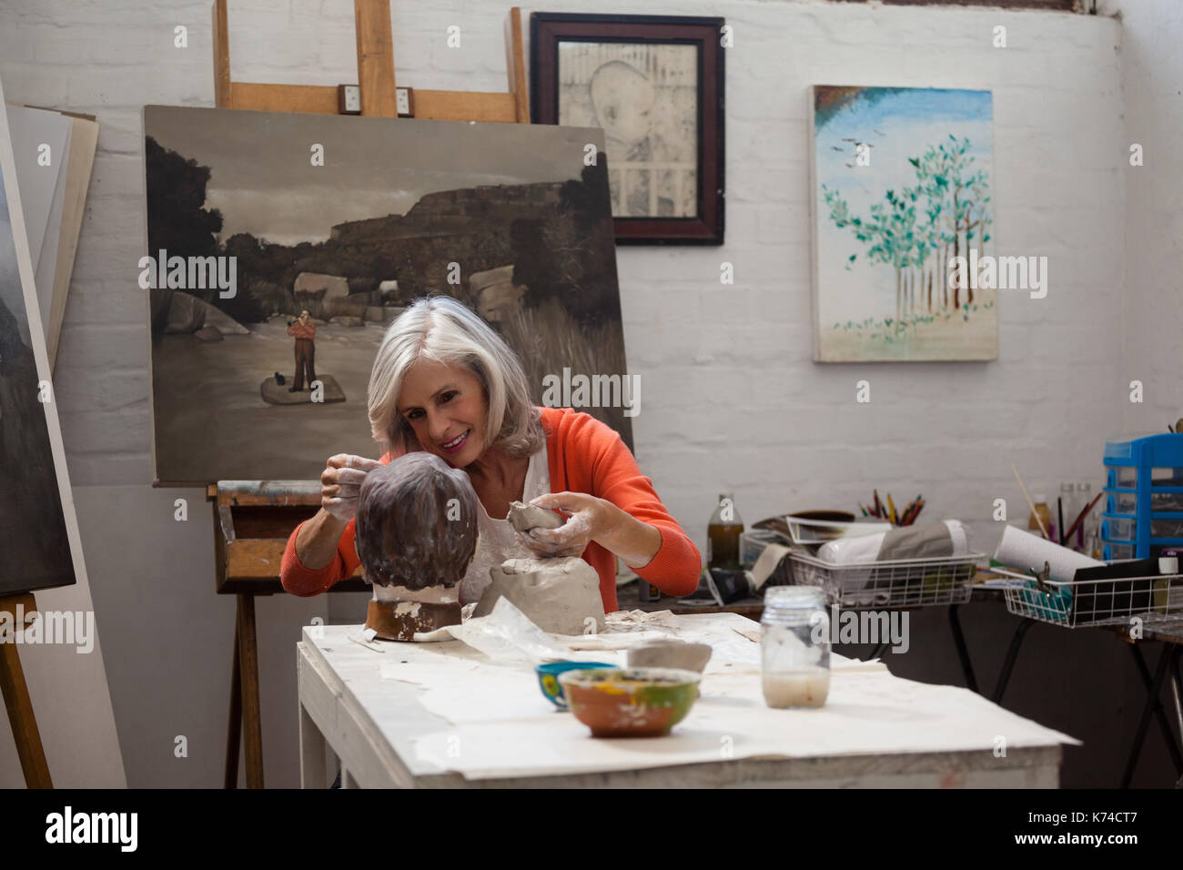 Woman creating clay sculpture hi-res stock photography and images - Alamy