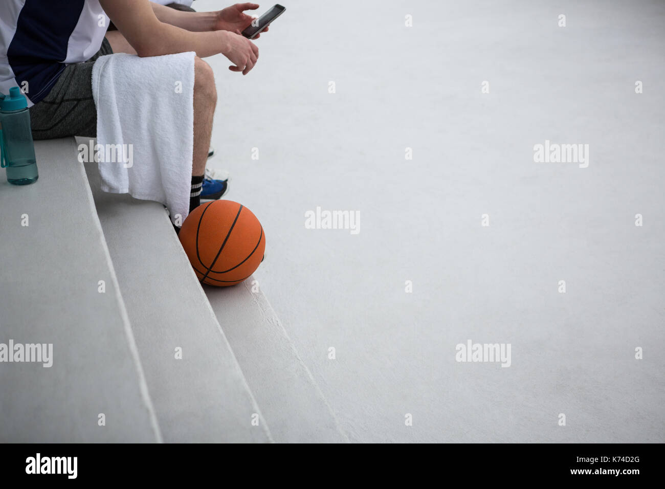 Basketball player using mobile phone on terrace Stock Photo - Alamy