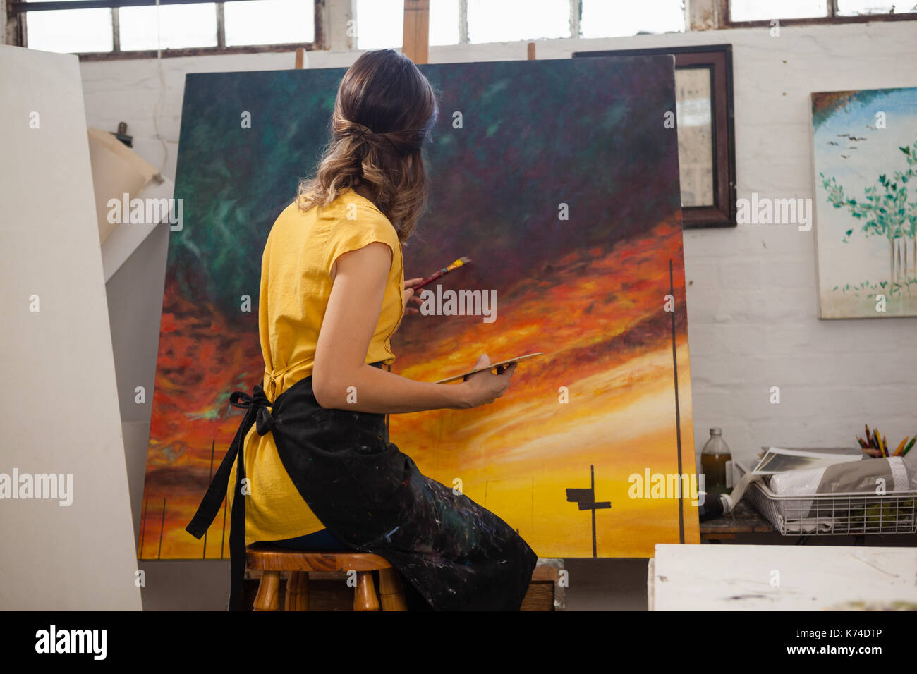 Woman painting on canvas in drawing class Stock Photo - Alamy