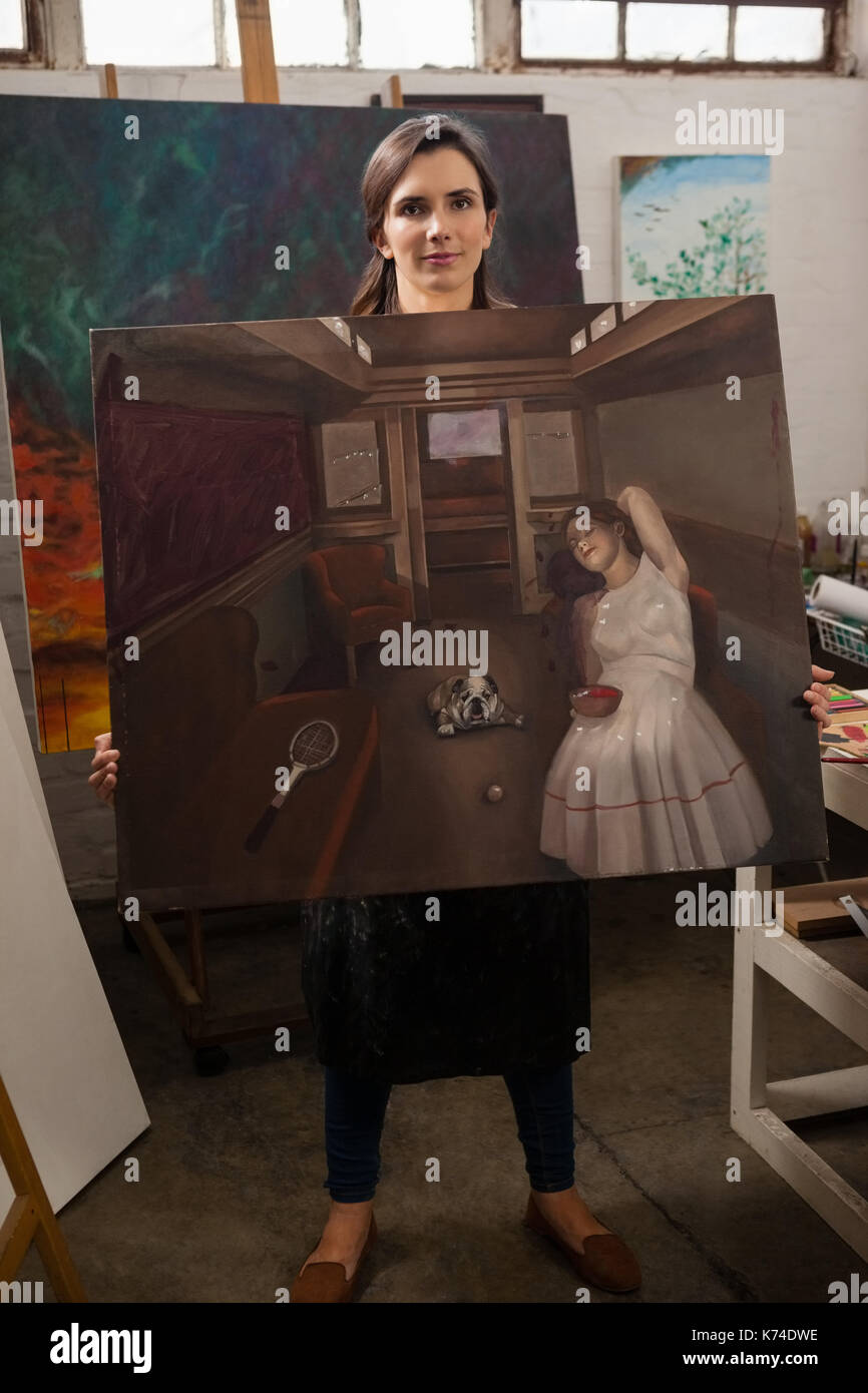 Portrait of woman holding a painting in drawing class Stock Photo - Alamy