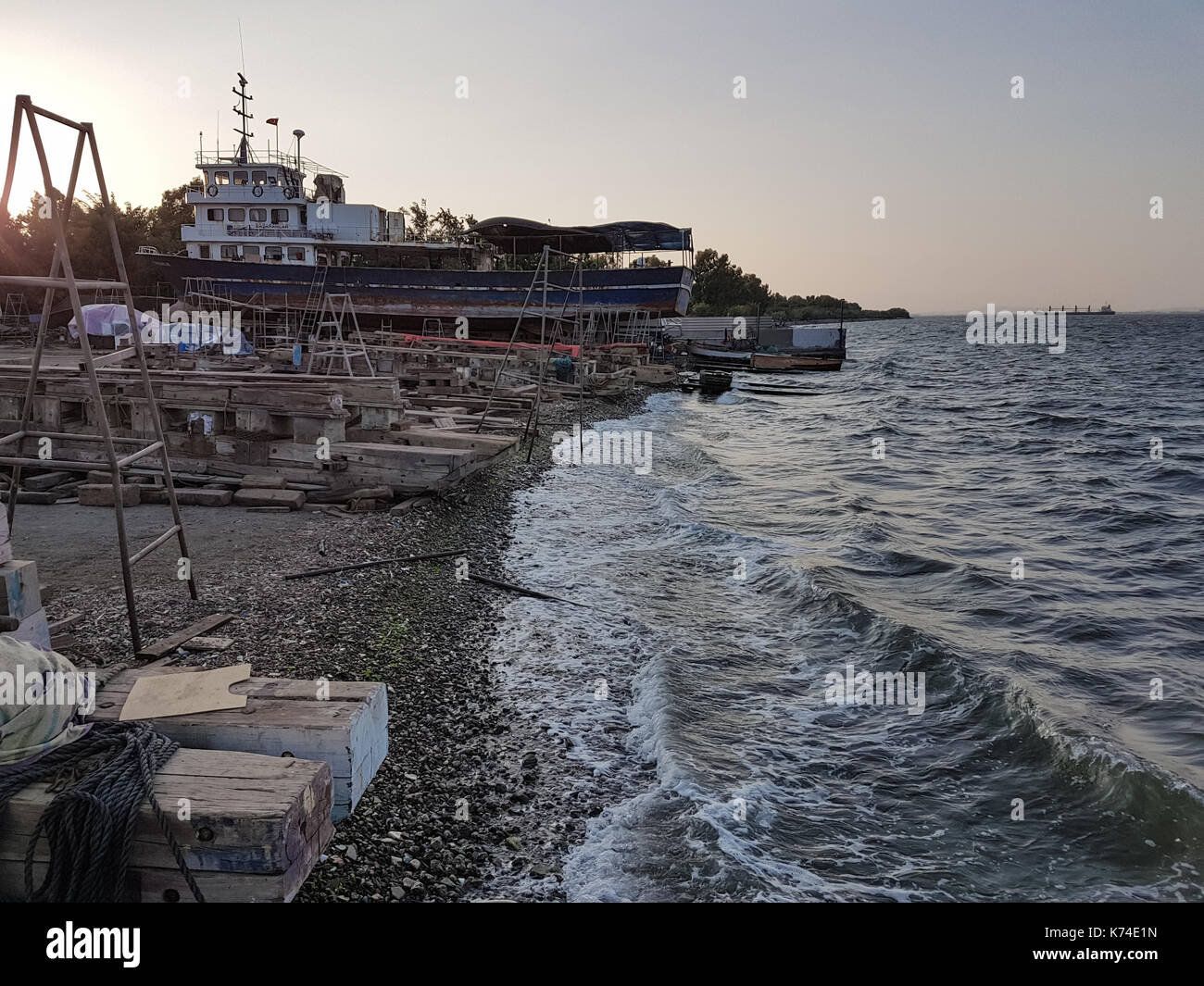 old ships are repaired at docks sunset Stock Photo - Alamy