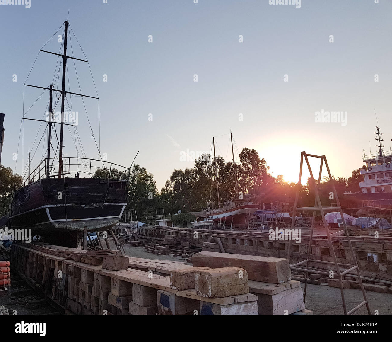 old ships are repaired at docks sunset Stock Photo - Alamy