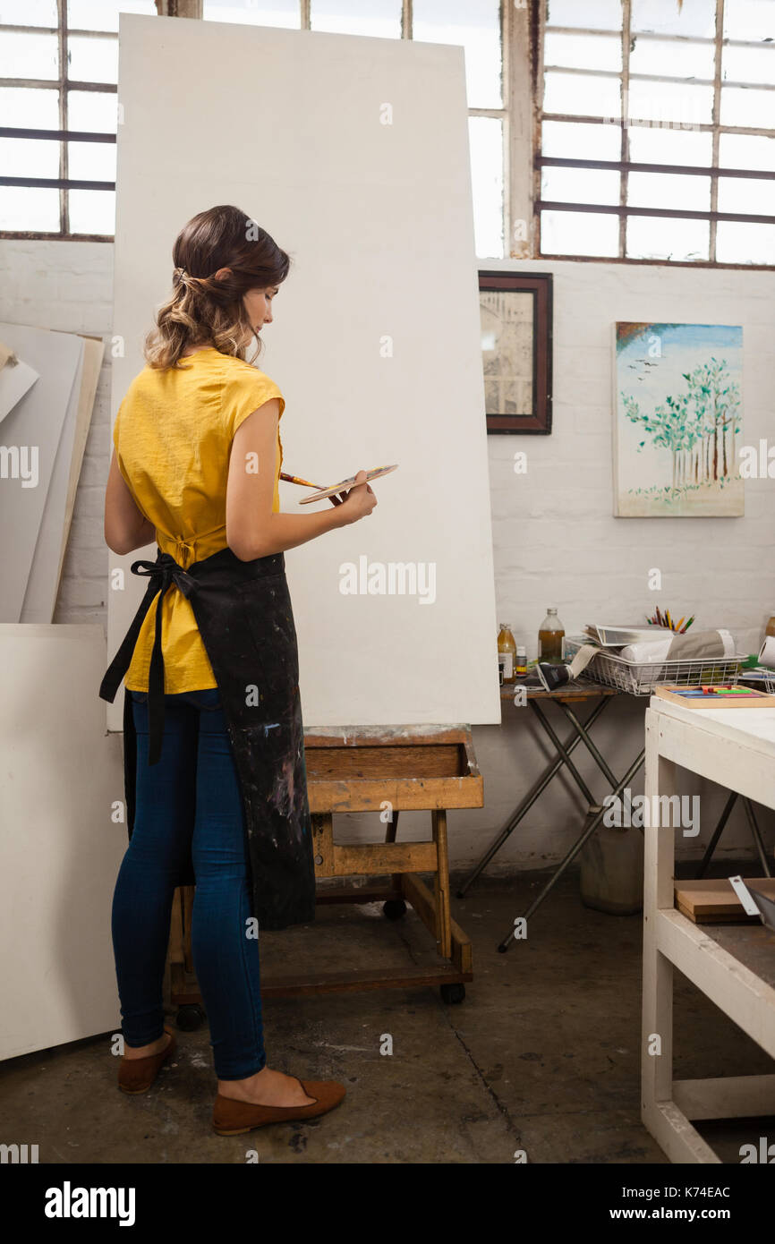 Woman painting on canvas in drawing class Stock Photo - Alamy