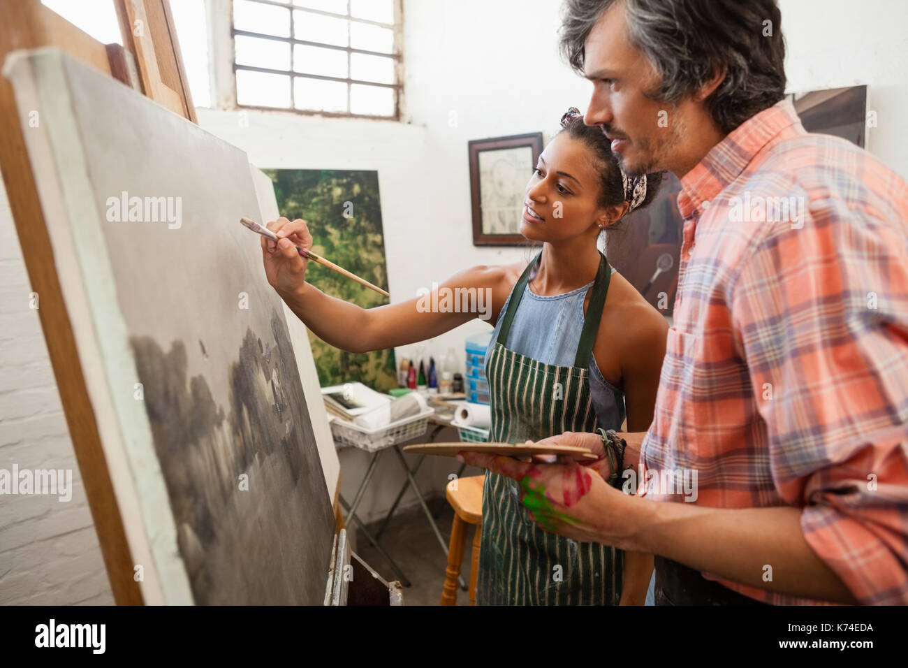 Woman painting during class hi-res stock photography and images - Alamy