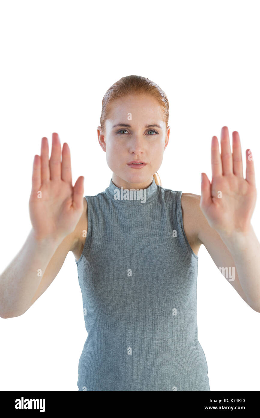 Portrait of young businesswoman showing stop gesture while standing ...