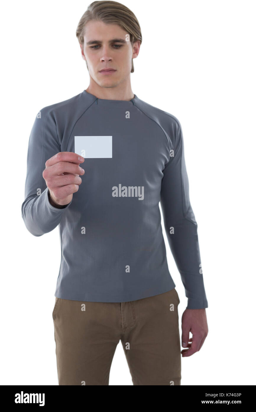 Businessman reading card while standing against white background Stock ...