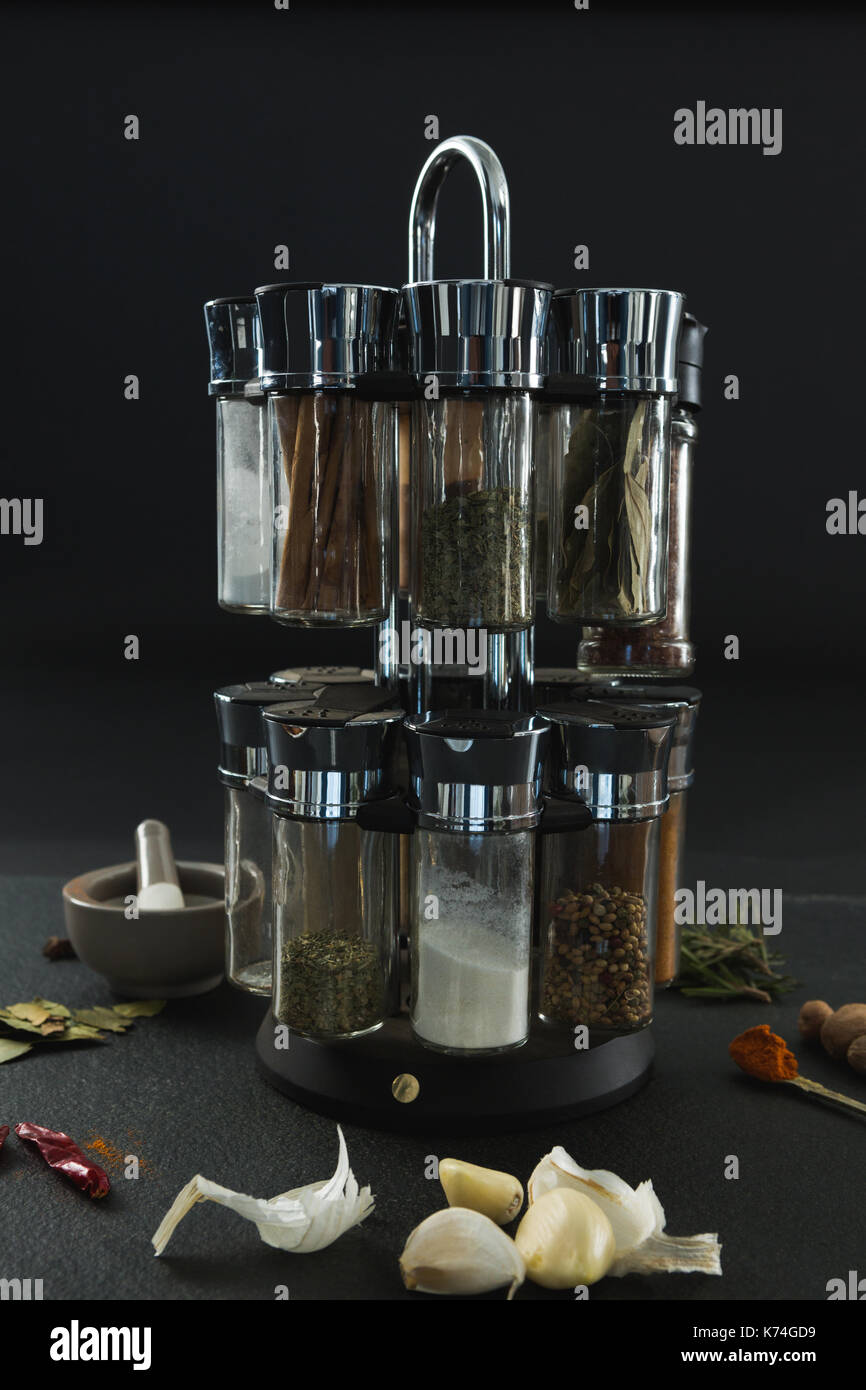 Various spices in a container against black background Stock Photo - Alamy