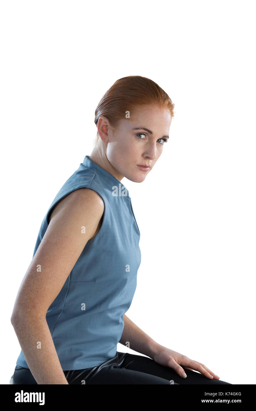 Portrait of angry businesswoman sitting against white background Stock ...