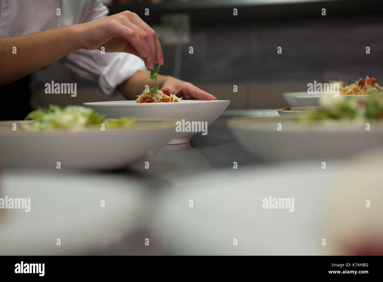 Female chef garnishing food on hi-res stock photography and images - Alamy