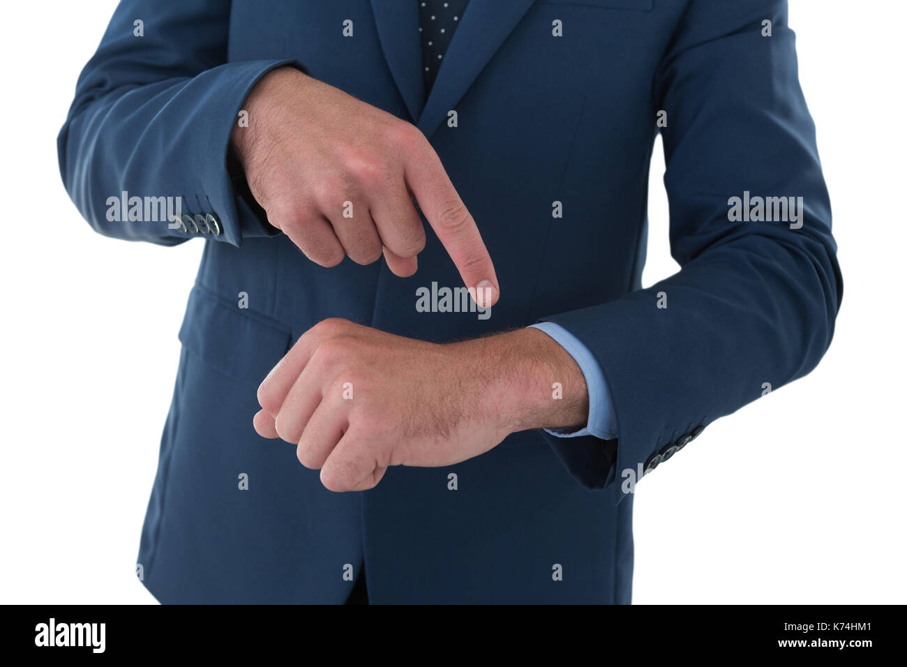 Mid section of businessman pointing on invisible wrist watch while ...