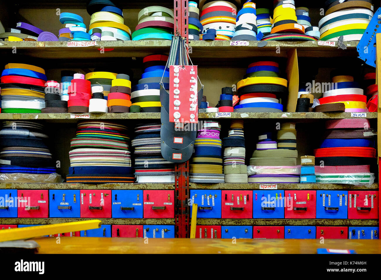 notions shop shelve with piles of colorful trimming tapes located in ...