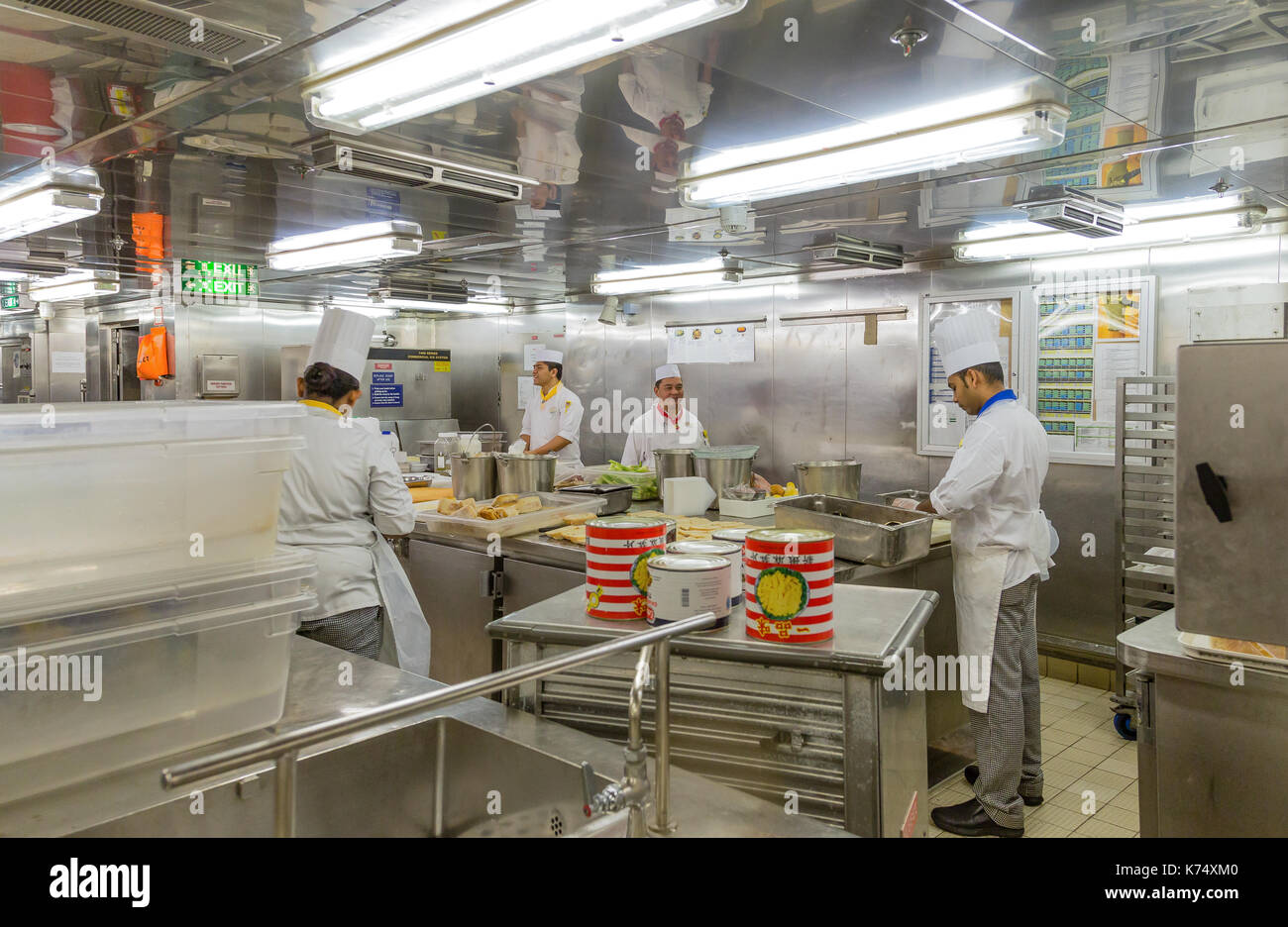 Busy cooks and workers in a commercial kitchen Stock Photo - Alamy