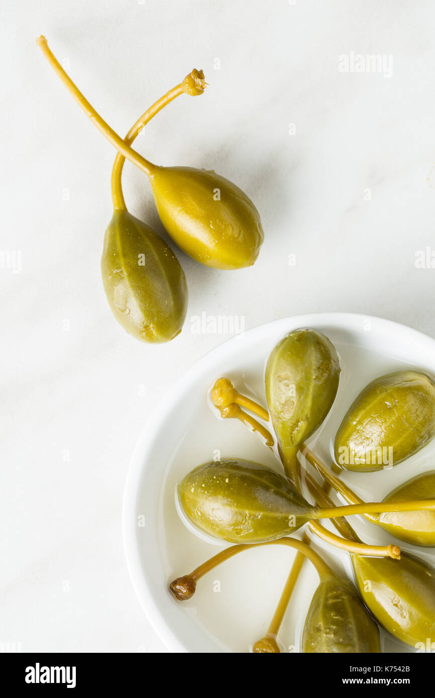 Pickled caper berries on kitchen table Stock Photo - Alamy