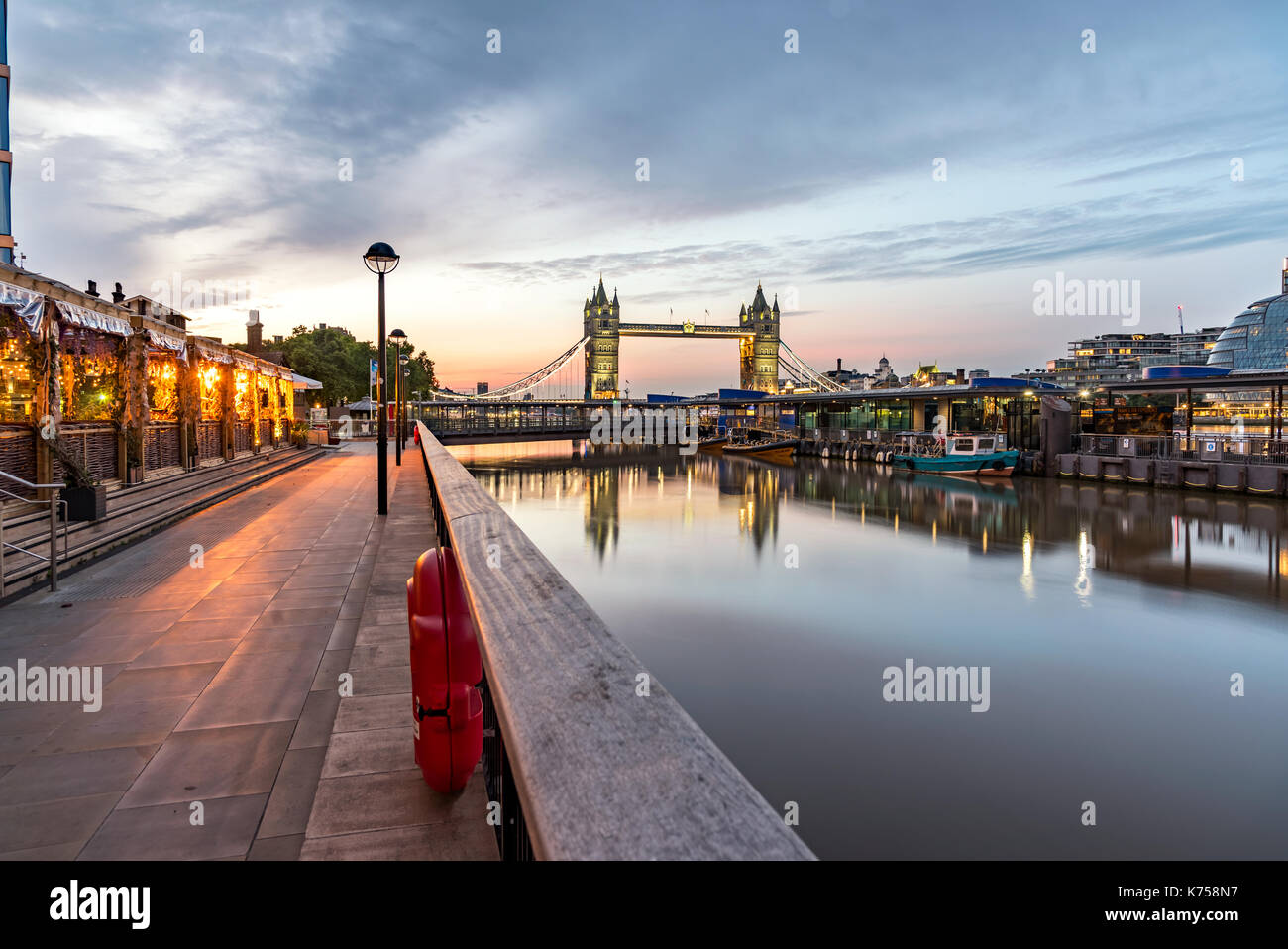Illuminated Tower Bridge and its reflection in clear water of river ...