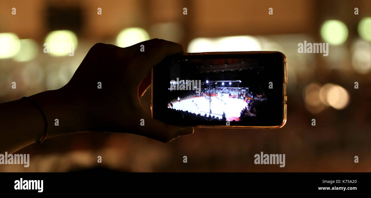 hand with the modern smartphone while shooting a video of a show Stock ...