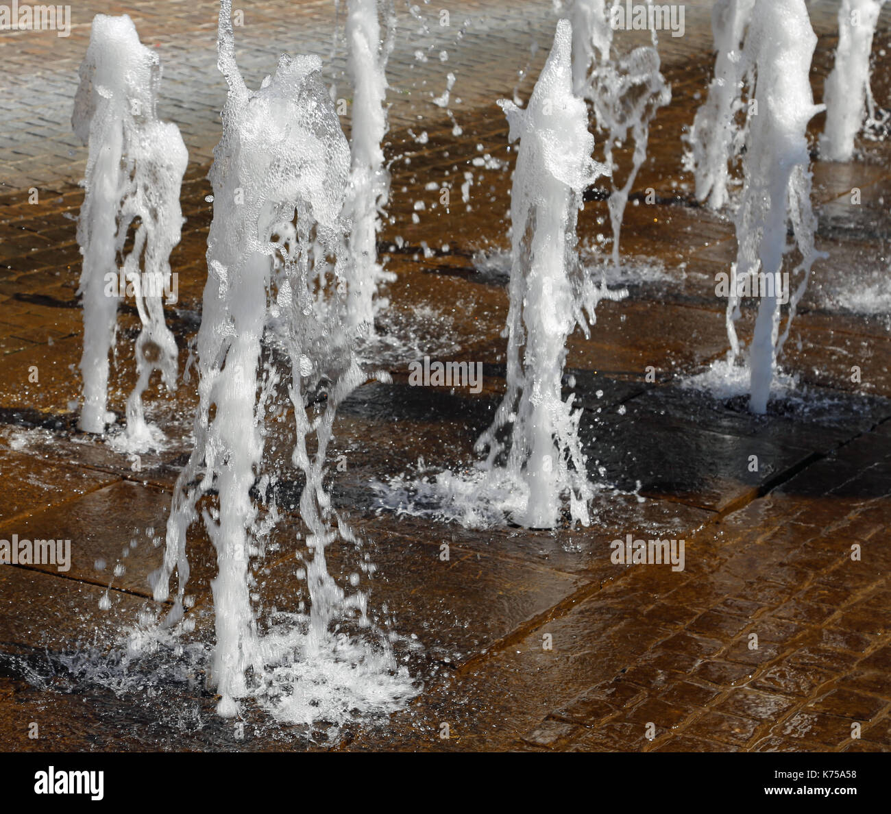 sprinkling water side of a floor fountain Stock Photo - Alamy