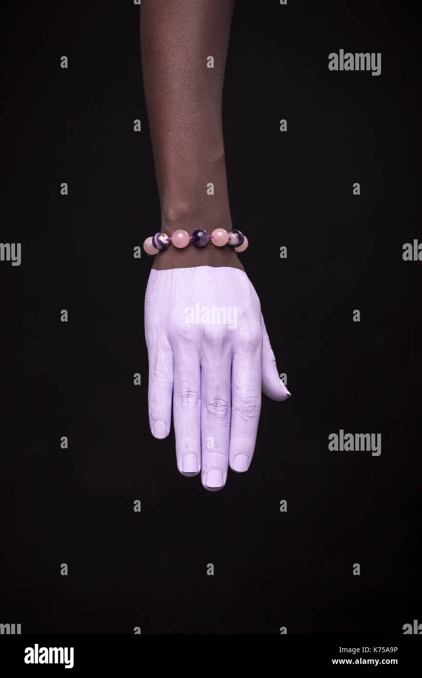 one woman hand, african american painted hand skin, black background ...