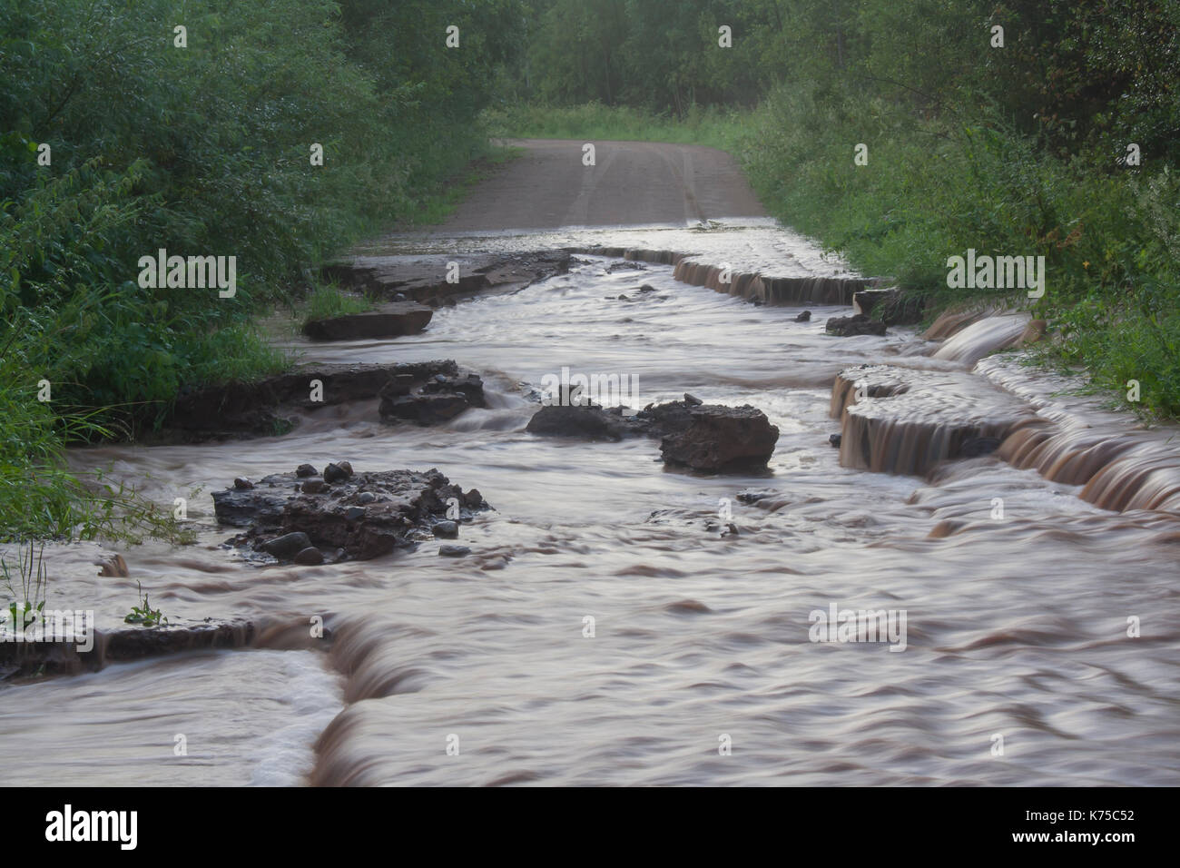 Water flows through a dirt road Stock Photo - Alamy