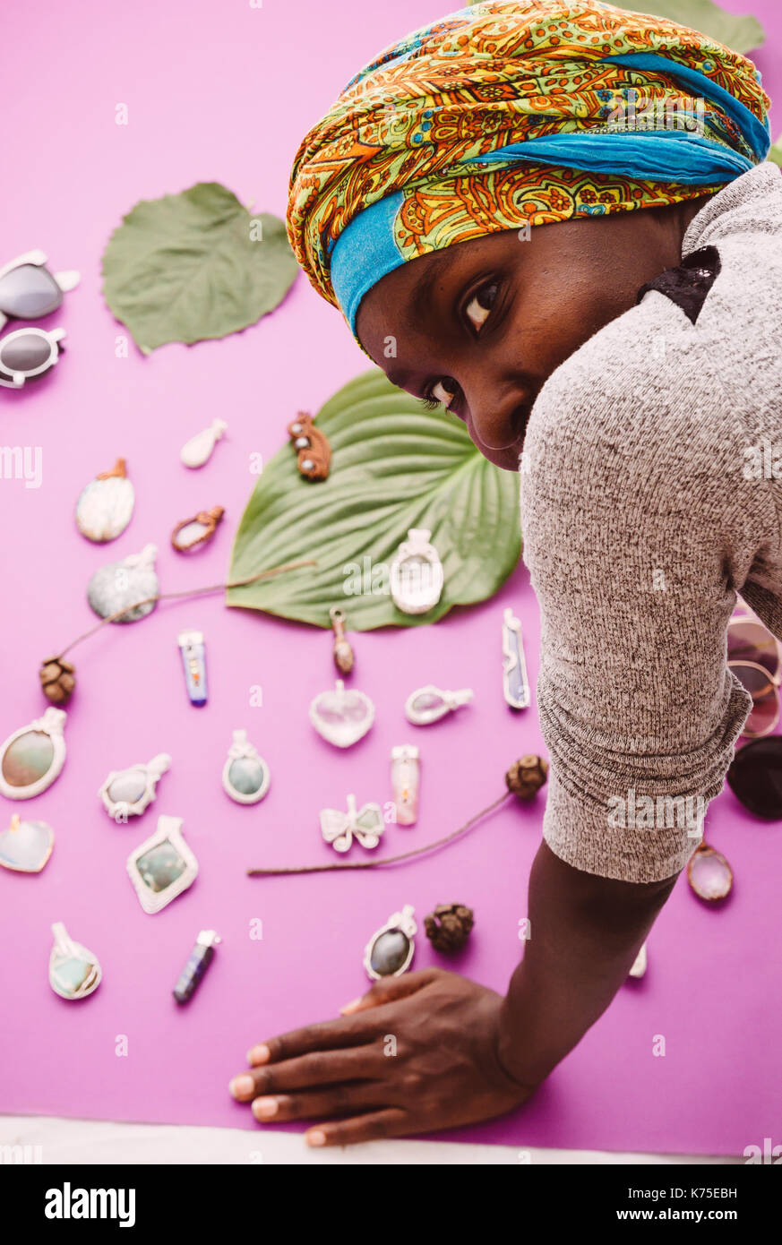 one young afro american woman, looking at camera, looking behind ...