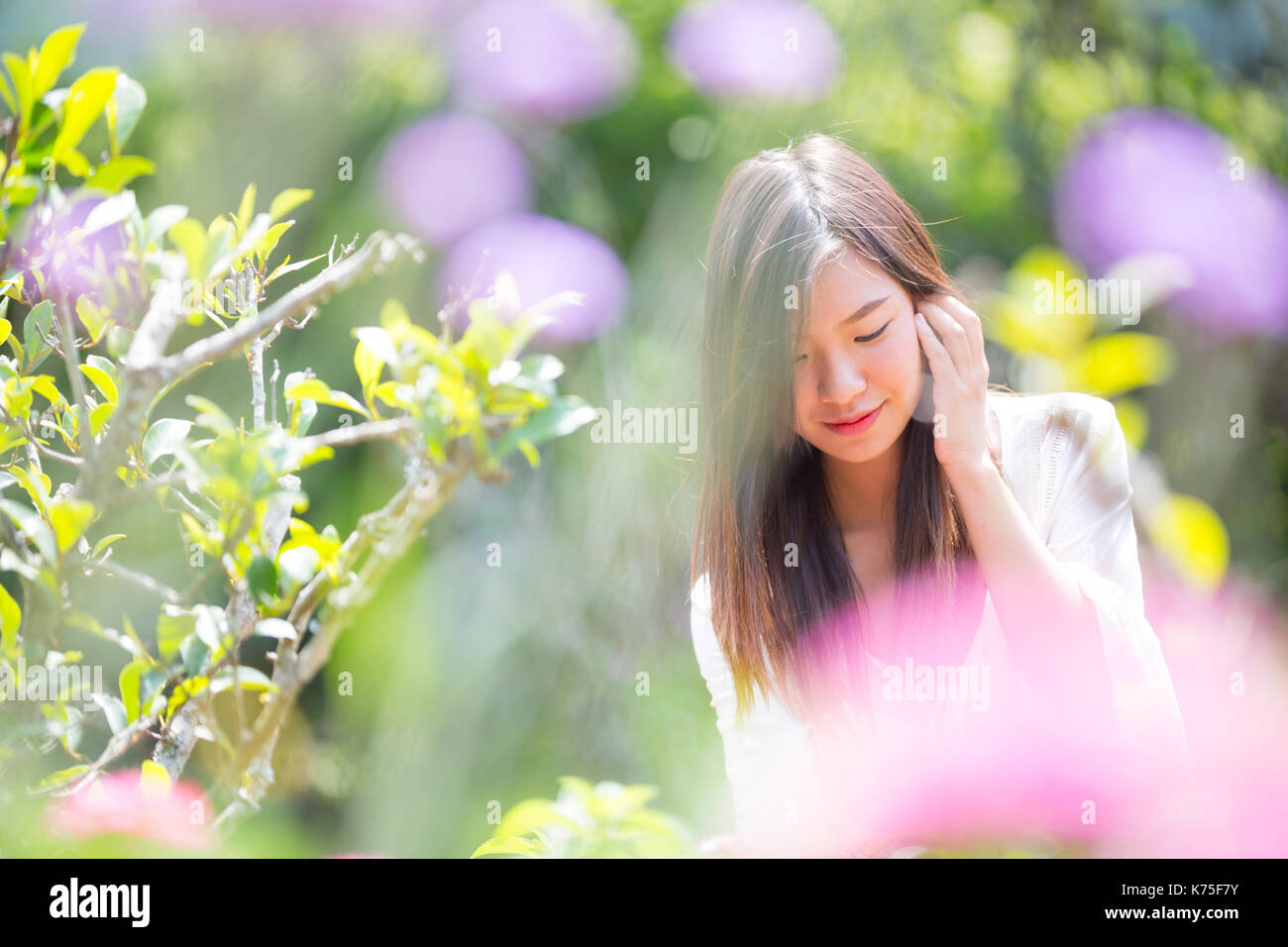 Women are watching flowers at the park Stock Photo - Alamy