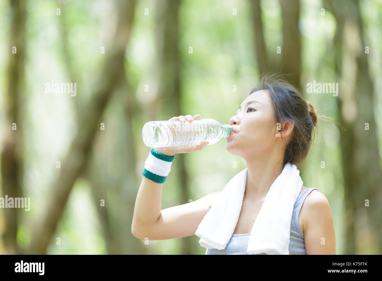 Girl drinking water exercise Stock Photo - Alamy