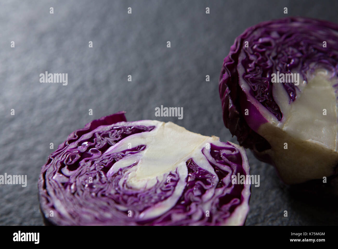 Close-up of halved red cabbage on black background Stock Photo - Alamy