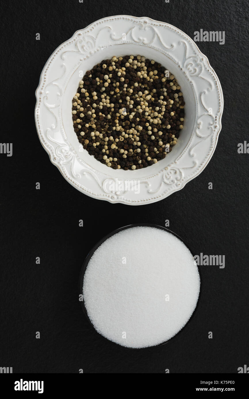 Overhead of black pepper, white pepper and salt in bowl Stock Photo - Alamy