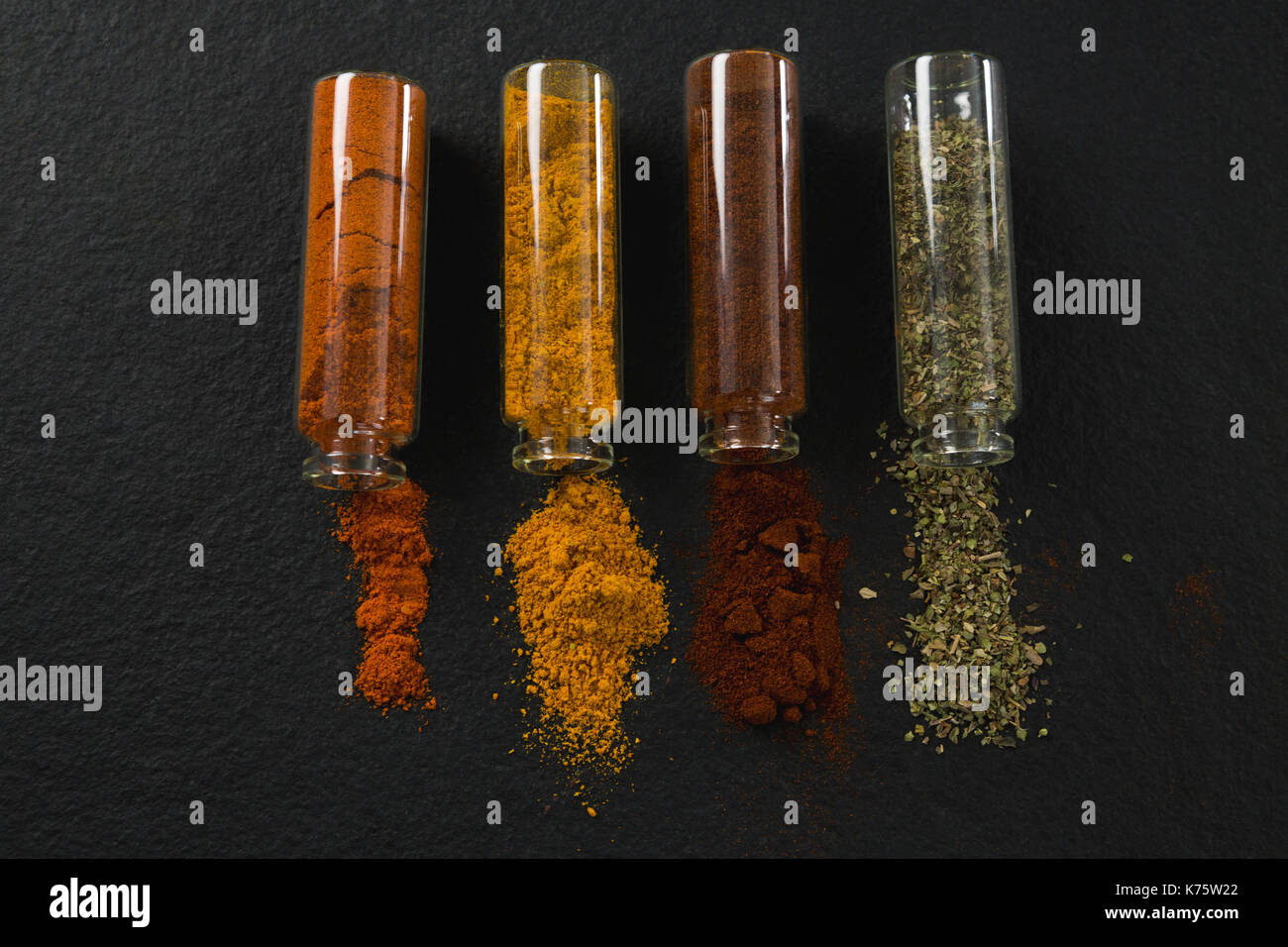Overhead of various spices spilling out of bottles Stock Photo - Alamy