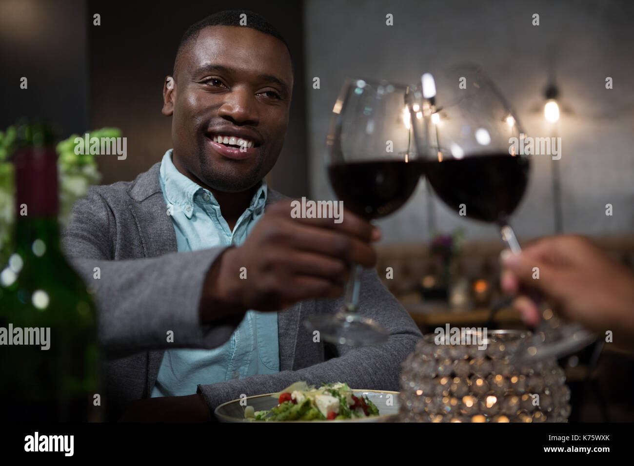 Man toasting red wine while dining in restaurant Stock Photo - Alamy